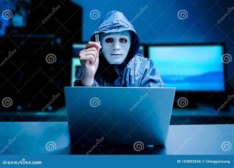 Anonymous Computer Hacker In White Mask And Hoodie Obscured Dark Face