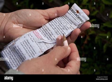 A Person Holding The Log Book For A Geocache Stock Photo Alamy