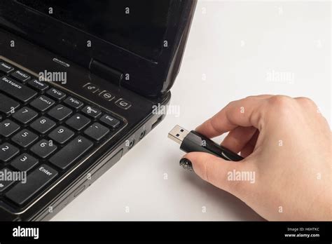 Hand Inserting Usb Memory Stick To Laptop Computer Stock Photo Alamy