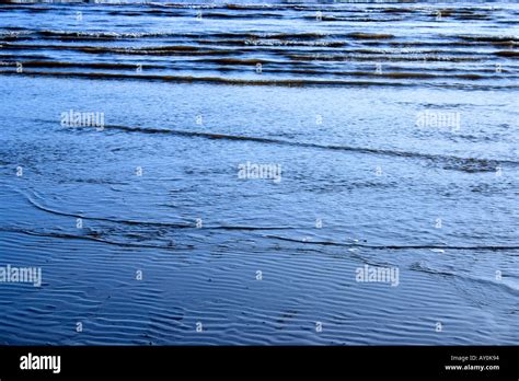 Sea With Waves Lapping Over Sand On Seashore Stock Photo Alamy