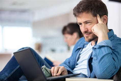 man smiling reads screen laptop computer stock image image of online