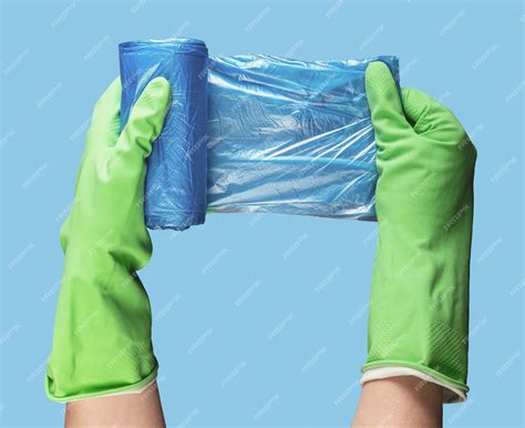 Premium Photo Garbage Trash Bag Roll In Hand In Green Glove Using New