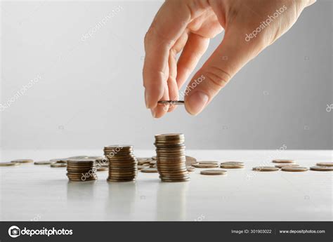 Woman Stacking Coins On White Wooden Table Closeup Stock Photo NewAfrica