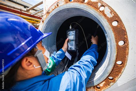 Worker Female Hand Holding Gas Detector Inspection Safety Gas Testing At Front Manhole Tank