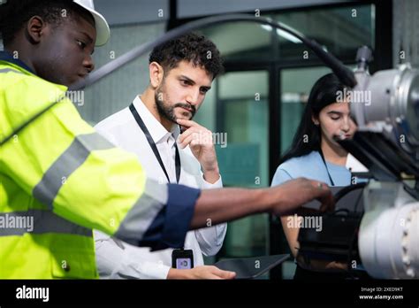 Technicians Are Introducing Industrial Hand Robots To Businessperson Of