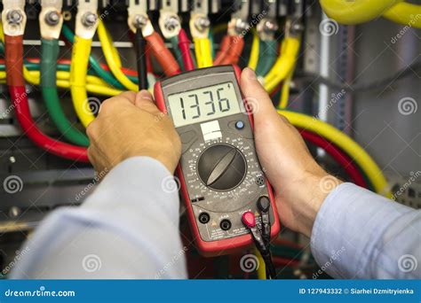 Electrical Tester In Hands Of Engineer Close Up Electrician Technician At Work Inspecting
