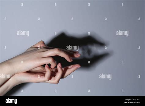 Shadow Puppet Woman Making Hand Gesture Like Crocodile On Grey