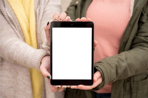 Free Photo Two Girls Presenting Tablet Mockup