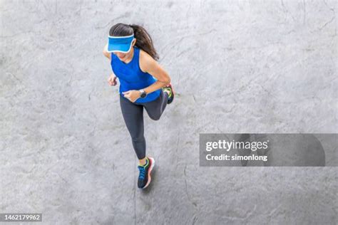 High Angle View Of Female Runner Running In Open Park High Res Stock