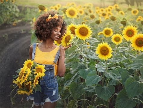 Happy Young Black Woman Walks In The Sunflower Field Smiling Dark