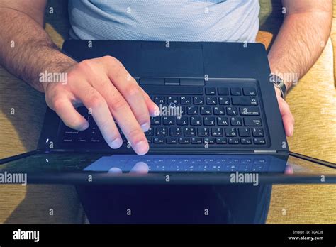 Man Works With A Laptop Touching The Screen With His Fingers Stock Photo Alamy