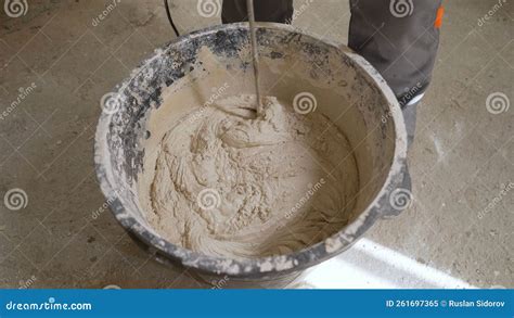 Mixing Cement Adhesive With A Mixer In A Bucket Close Up Texture Of A Mixed Mortar A Worker