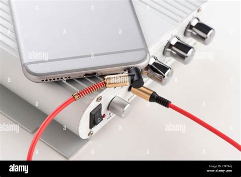 Aux Cable Connected Between Smartphone And Mini Amplifier Cable For