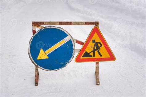 Construction And Detour Signs Positioned In Snowy Environment