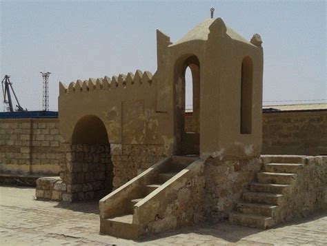 An Adobe Building With Steps Leading Up To It