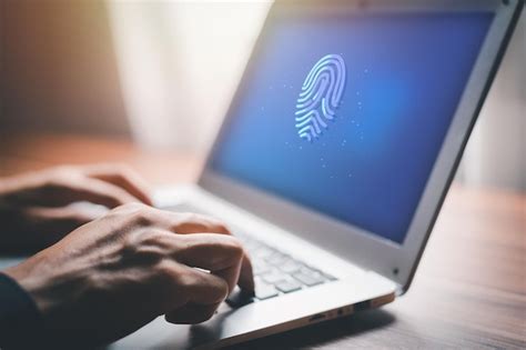 Premium Photo Man Using A Laptop With A Security Scan Fingerprint