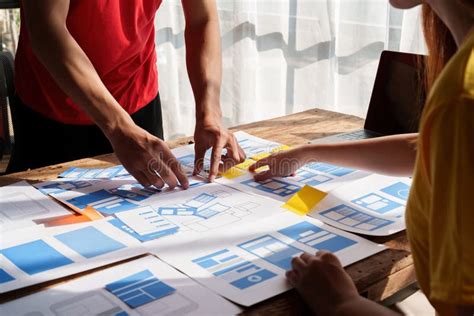 Group Of Ux Developer And Ui Designer Brainstorming About App Interface Design At Modern Office