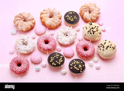 Various Types Of Donuts And Other Cakes On Pink Background Party Dessert Stock Photo Alamy