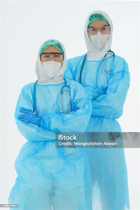 Ppe 커버올 슈트 커버에 있는 남성과 여성 의사들은 일회용 의료 용 가운과 의료 용 얼굴 마스크 및 보호 고글을 사용하여