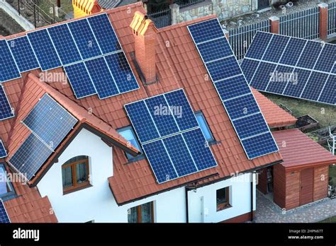 Private Home Roof Covered With Solar Photovoltaic Panels For Generating Of Clean Ecological