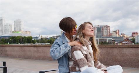 Two Lesbian Women Sit On The Embankment And Enjoy Each Other One Woman