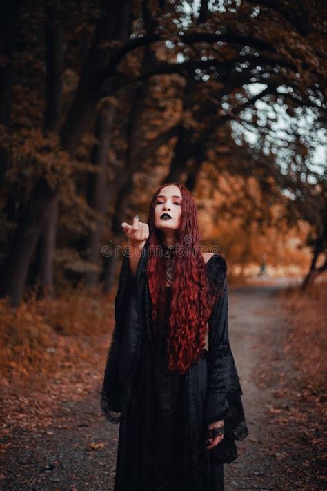 Portrait Of Redhead Woman In A Black Dress Dressed As A Witch Goth Halloween Stock Image