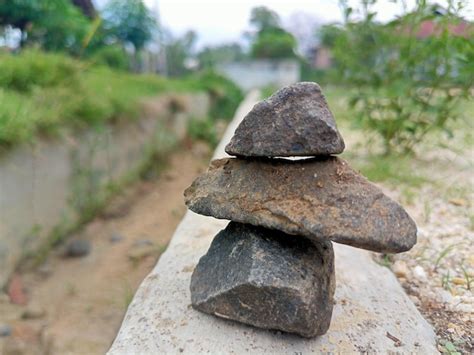 Premium Photo Photo A Balanced Stack Of Rocks On A Concrete Wall
