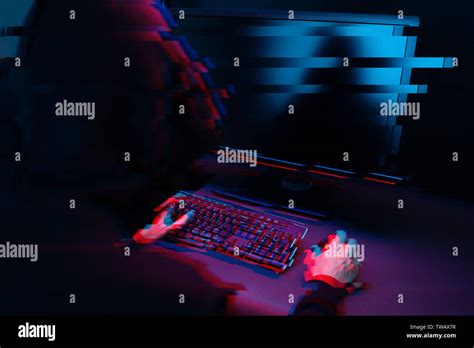 Hacker In The Hood Working With Computer Typing Text In Dark Room