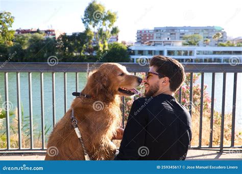Young Latino Man With Sunglasses And Beard And His Brown Golden