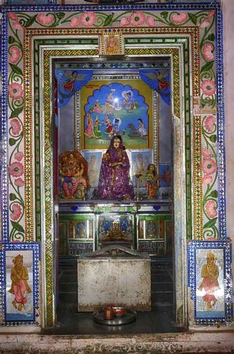 Vertical Shot Of An Altar At The Hindu Temple With Murals Religious