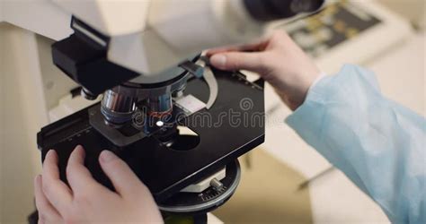 Scientist Examining Samples With Microscope In Laboratory At Night