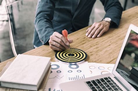 Premium Photo Midsection Of Man Holding Dart Over Dartboard While