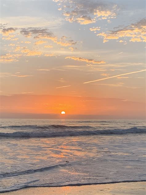 Beach Aesthetic Sunset Orange Tones Blue Waves And Fluffy White Clouds
