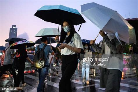 People Walk Under The Rain As Typhoon Ma On Hits Guangzhou On August