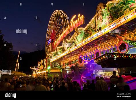 Fun Fair In The Evening Fairground Ride And Big Wheel Germany Baden