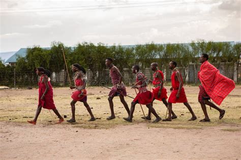 Masai In Traditional Colorful Clothing Showing Maasai Jumping Dance At
