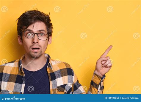 Young Funny Nerd Guy Pointing To Free Copy Space For Text On Yellow