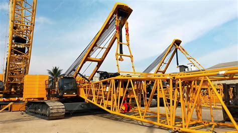 Premium Photo Two Big Yellow Crawler Crane Assembling The Boom And