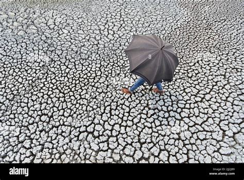 Cracked Dry Farmland Under Scorching Sun Symbolizing Drought Climate