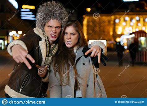 Male And Female Friends Goofing Off On The City Streets Night Out