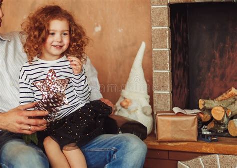 Happy Dad With His Little Daughter Sitting In A Cozy Living Room Stock