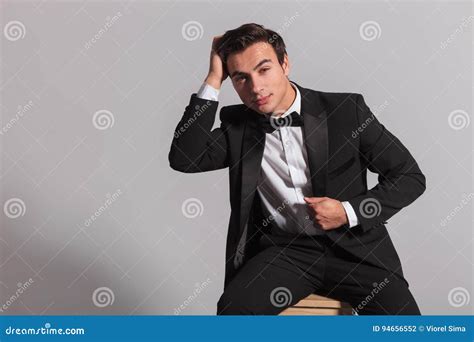 Seated Elegant Man In Tuxedo Fixing His Hairstyle Stock Photo Image Of Hold Arrange 94656552