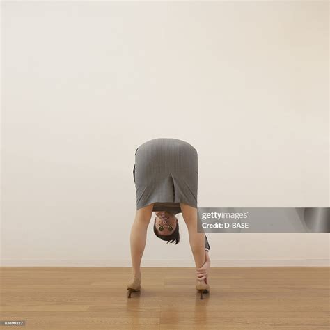 Business Woman Bending Over Looking Between Legs Photo Getty Images