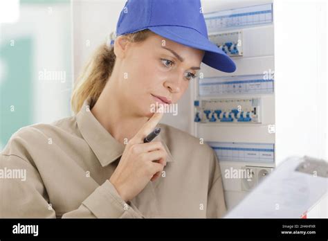 Contemplative Female Electrician Stood By Electric Meter Stock Photo Alamy