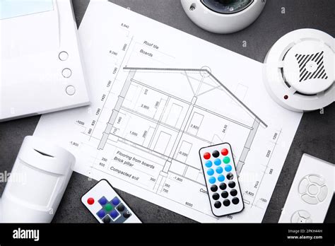 Building Plan Remote Controls Smoke And Movement Detectors On Grey Table Flat Lay Home