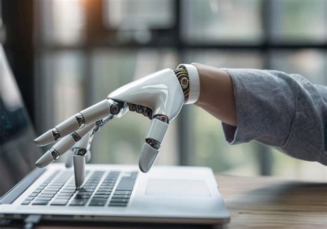 Premium Photo A Robotic Hand Is Typing On A Laptop Keyboard