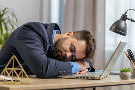 bored sleepy caucasian business man worker working on laptop computer
