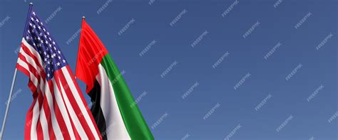 Premium Photo Us And Uae Flags On Flagpoles On Side Flags On A Blue