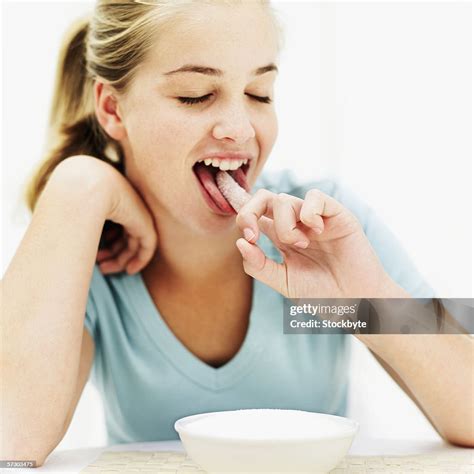 Closeup Of A Young Girl Licking Sugar Off Her Finger High Res Stock