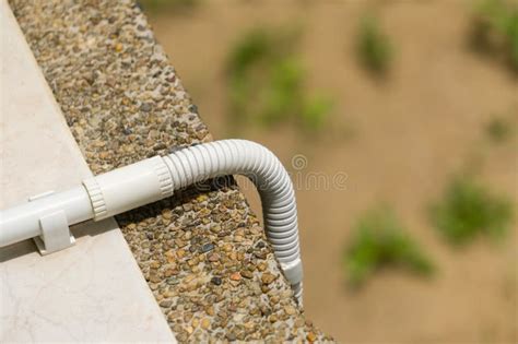 White Plastic Pipe Hose In An Angular Angle Setting With Clamp Stock